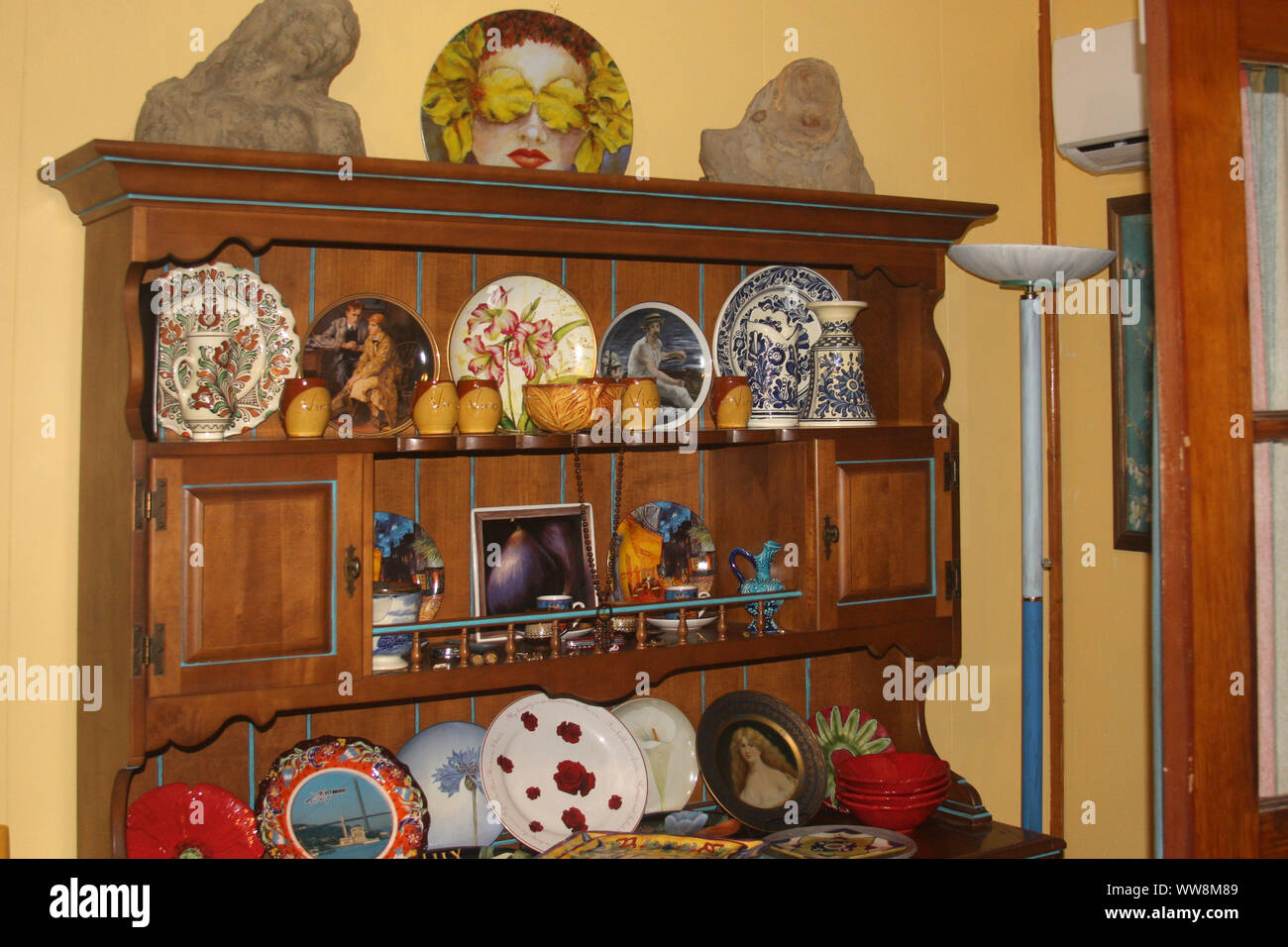 Decorative plates in a cupboard Stock Photo - Alamy