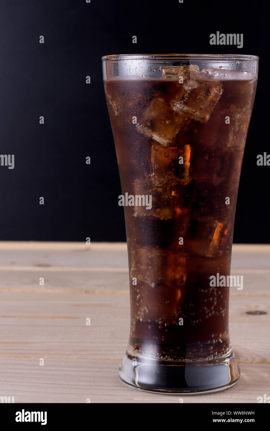 Glass of cola with ice cube, copy space Stock Photo - Alamy