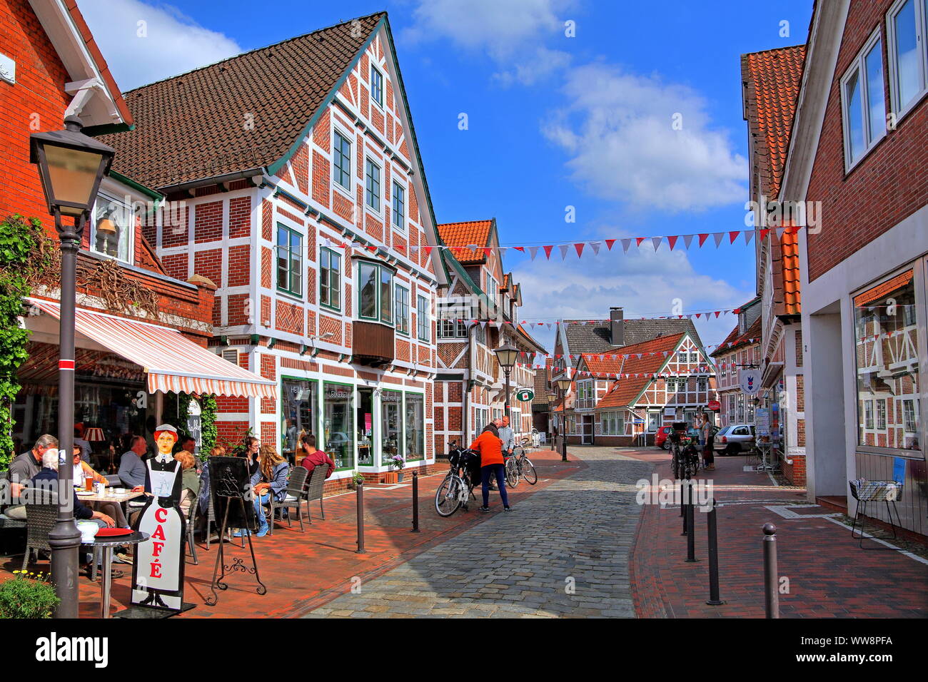 Village street with street cafe and half-timbered houses, Jork, Lower ...