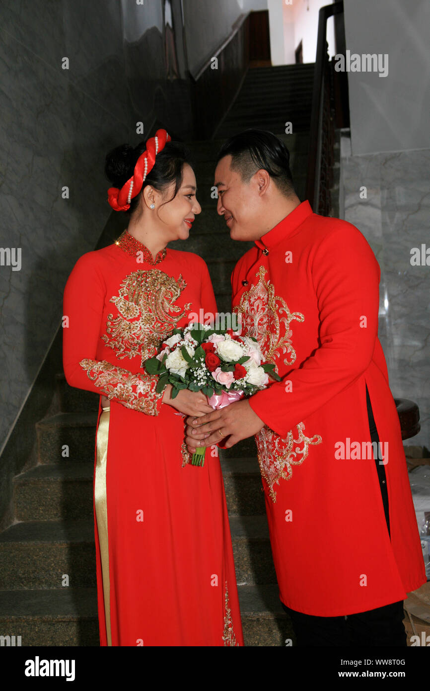 The bride and groom wear traditional red dresses Stock Photo - Alamy