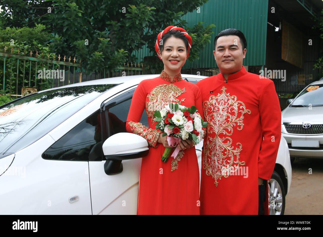 The bride and groom wear traditional red dresses Stock Photo - Alamy