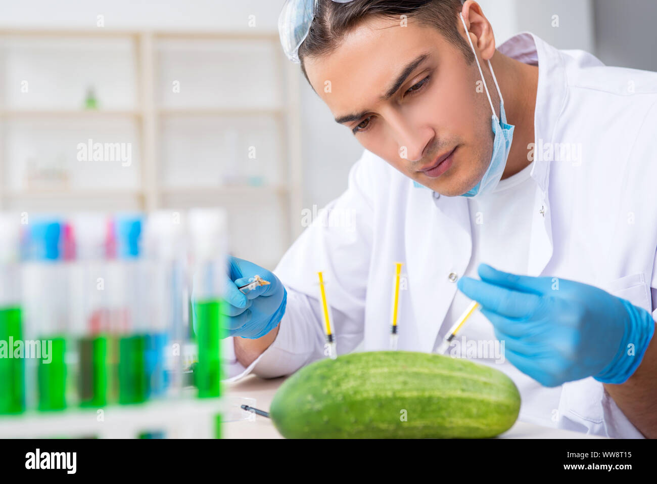 The male nutrition expert testing vegetables in lab Stock Photo - Alamy