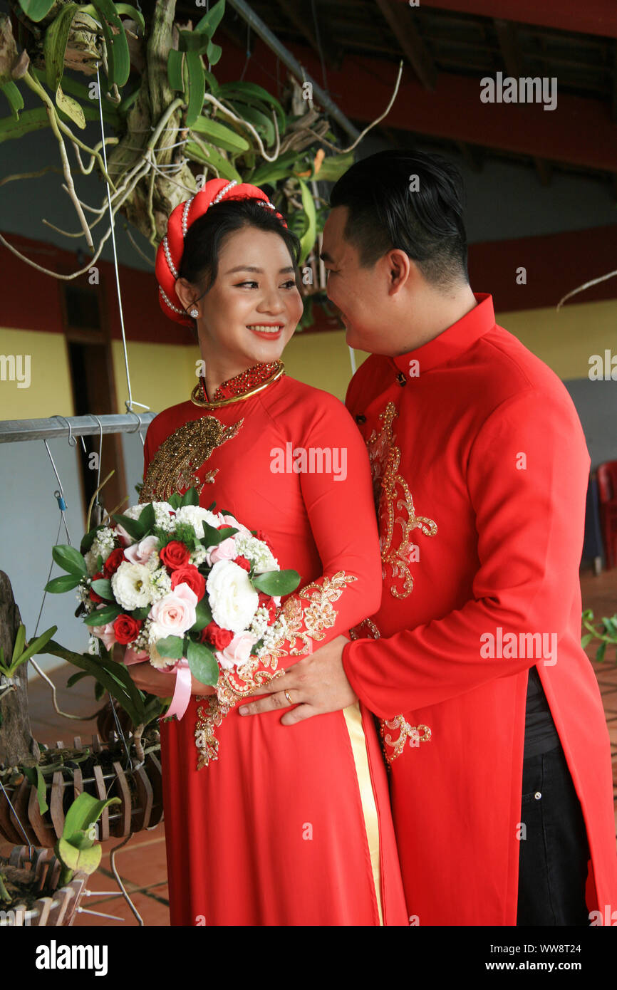 The bride and groom wear traditional red dresses Stock Photo - Alamy