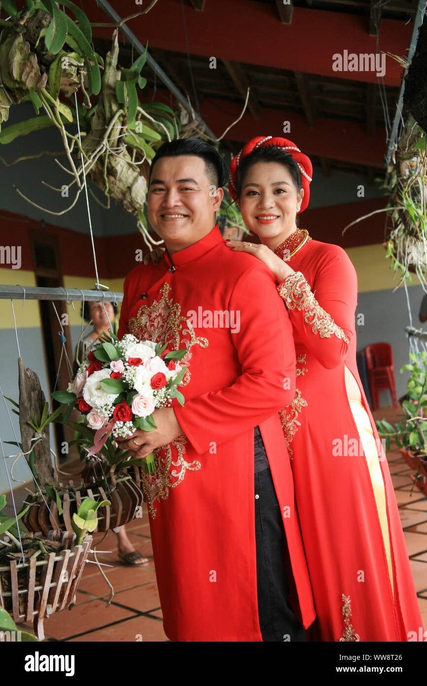 The bride and groom wear traditional red dresses Stock Photo - Alamy