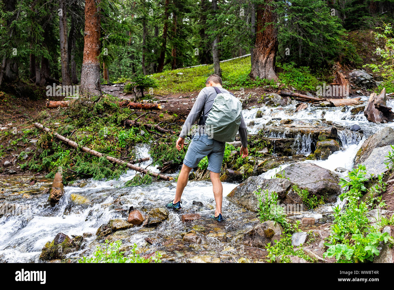 Man crossing river on Conundrum Creek Trail in Aspen, Colorado in 2019 ...