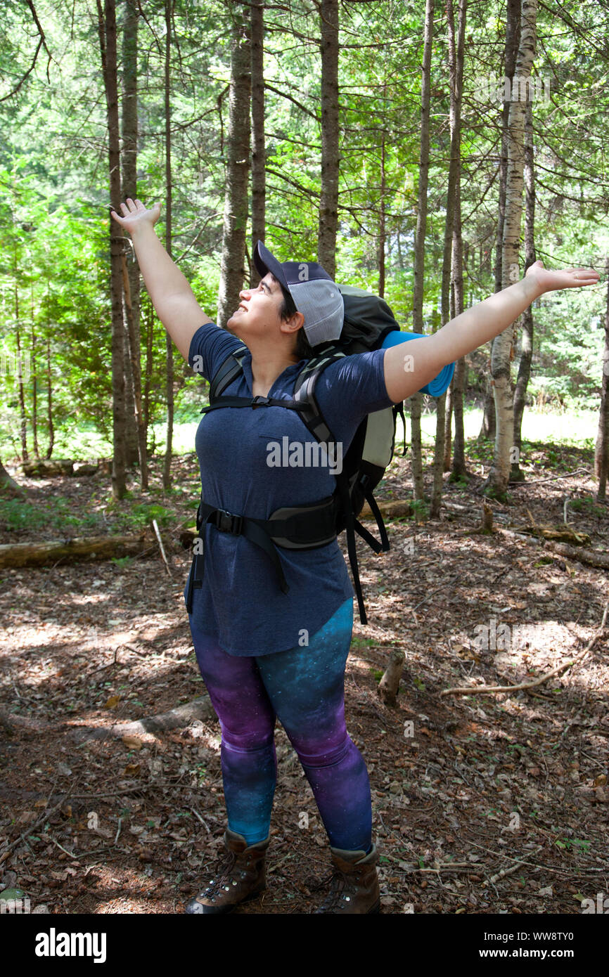 Arms open wide in nature smiling about being in nature Stock Photo - Alamy