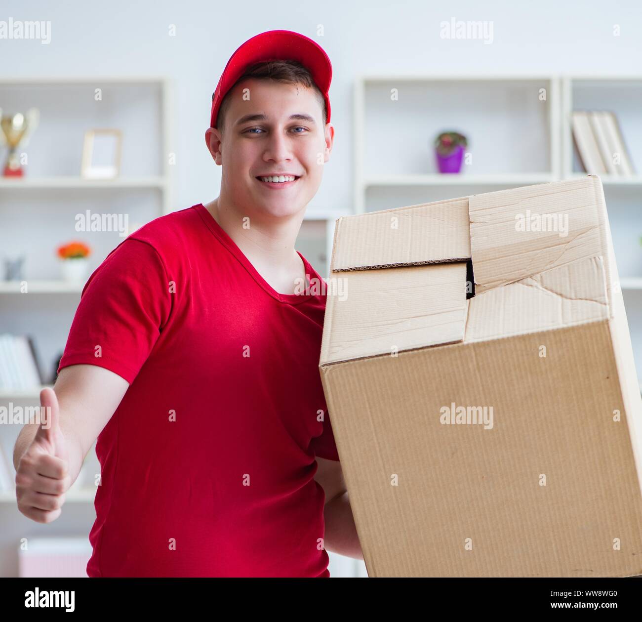 The post man delivering a parcel package Stock Photo - Alamy
