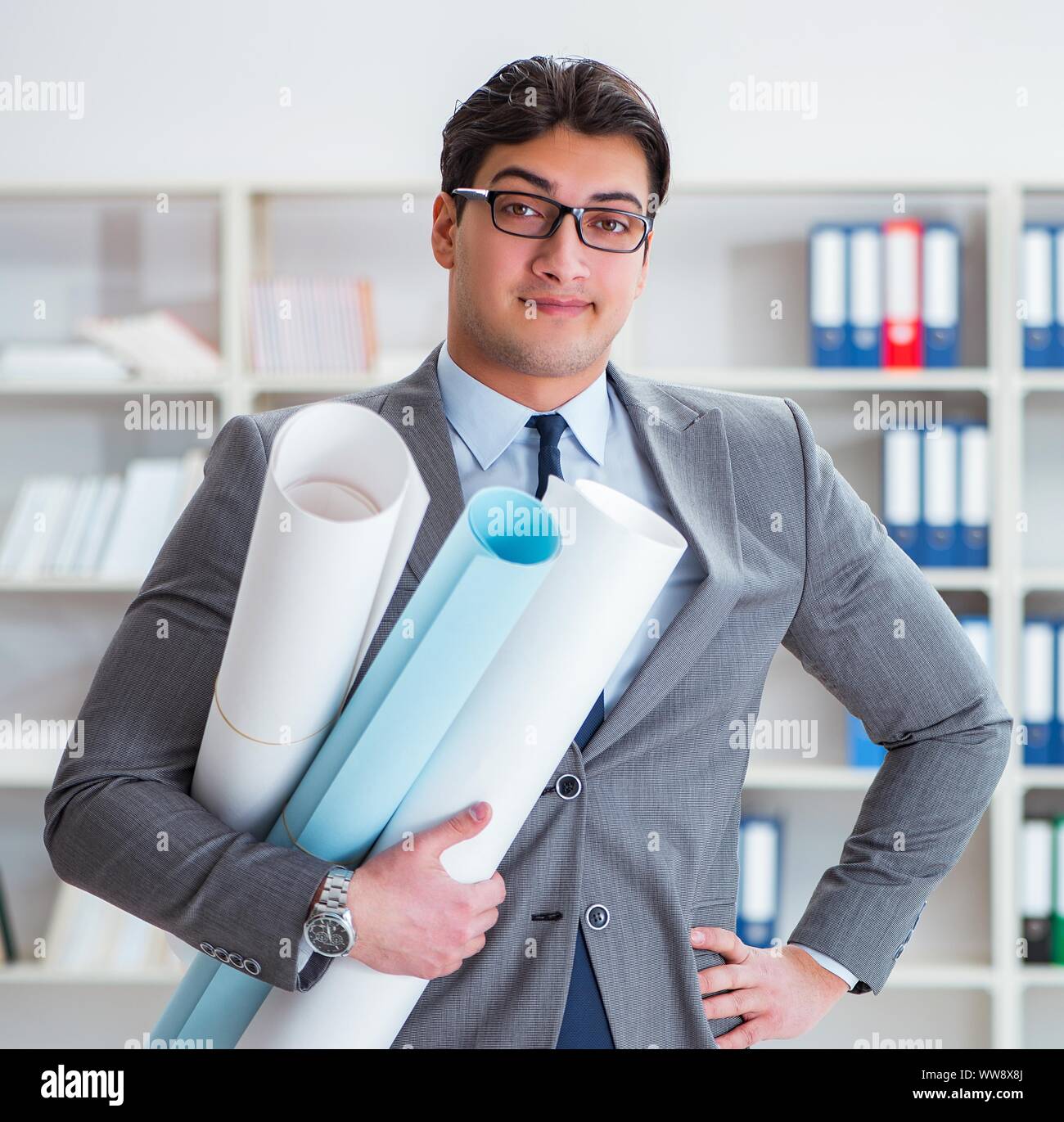 The businessman engineer draftsman with blueprints drawings Stock Photo ...