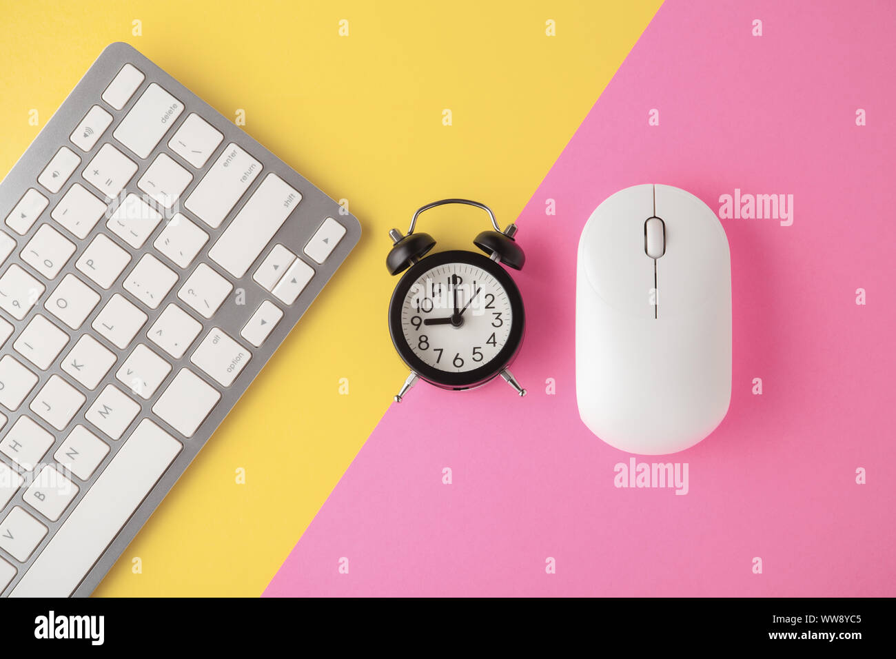 Wireless keyboard and mouse with clock on yellow pink background ...