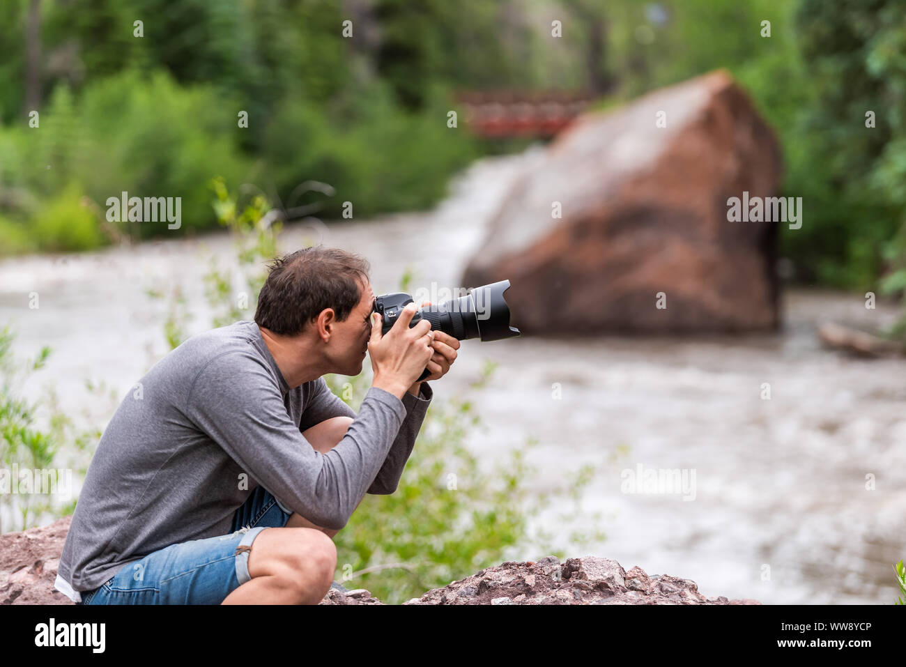 Man taking pictures with camera in Redstone, Colorado during summer ...