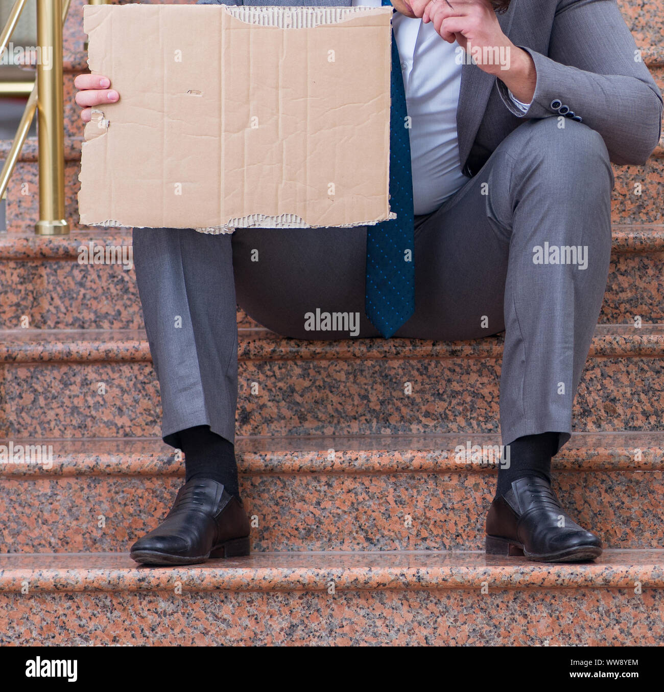 The desperate businessman begging on the street Stock Photo - Alamy