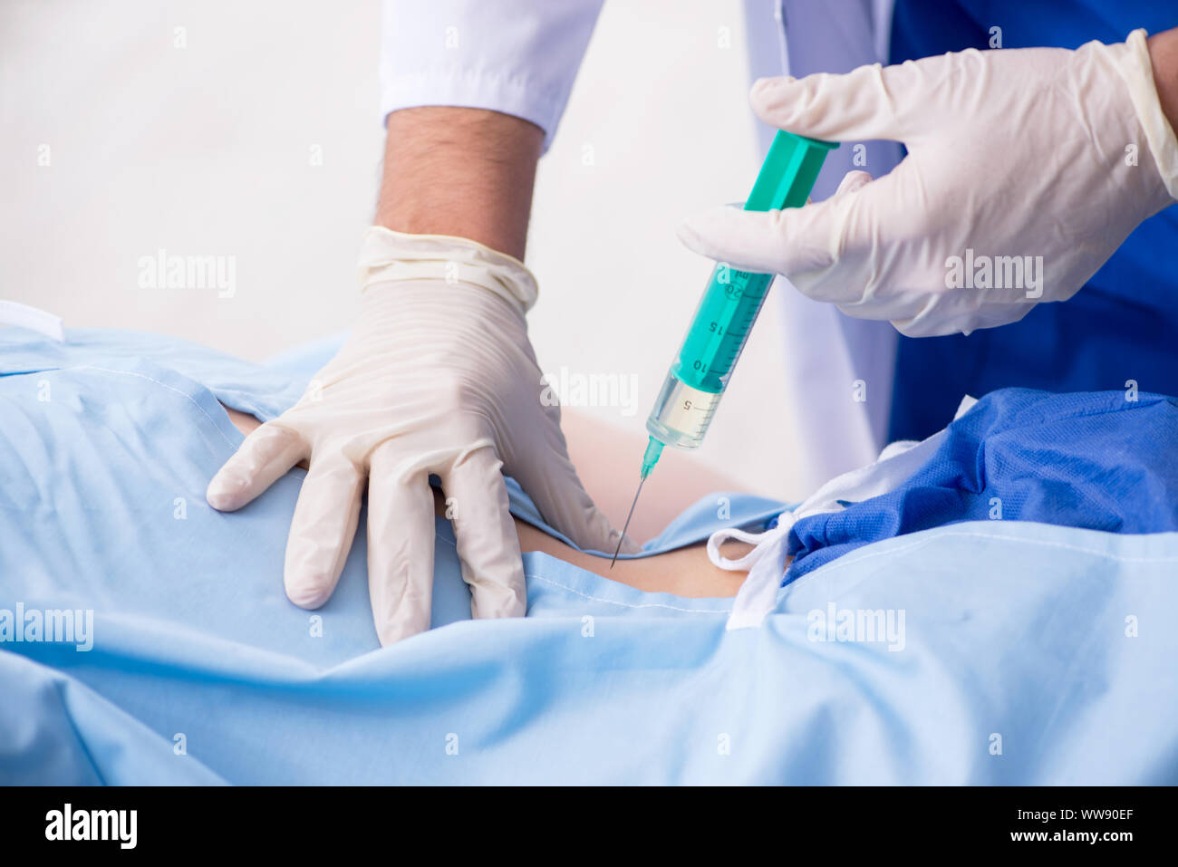The female patient getting an injection in the clinic Stock Photo - Alamy