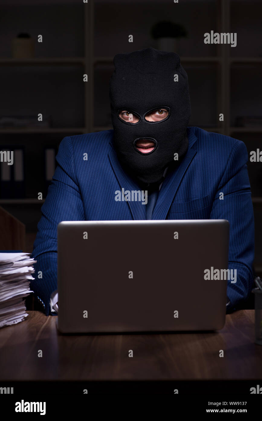 The male employee stealing information in the office night time Stock ...