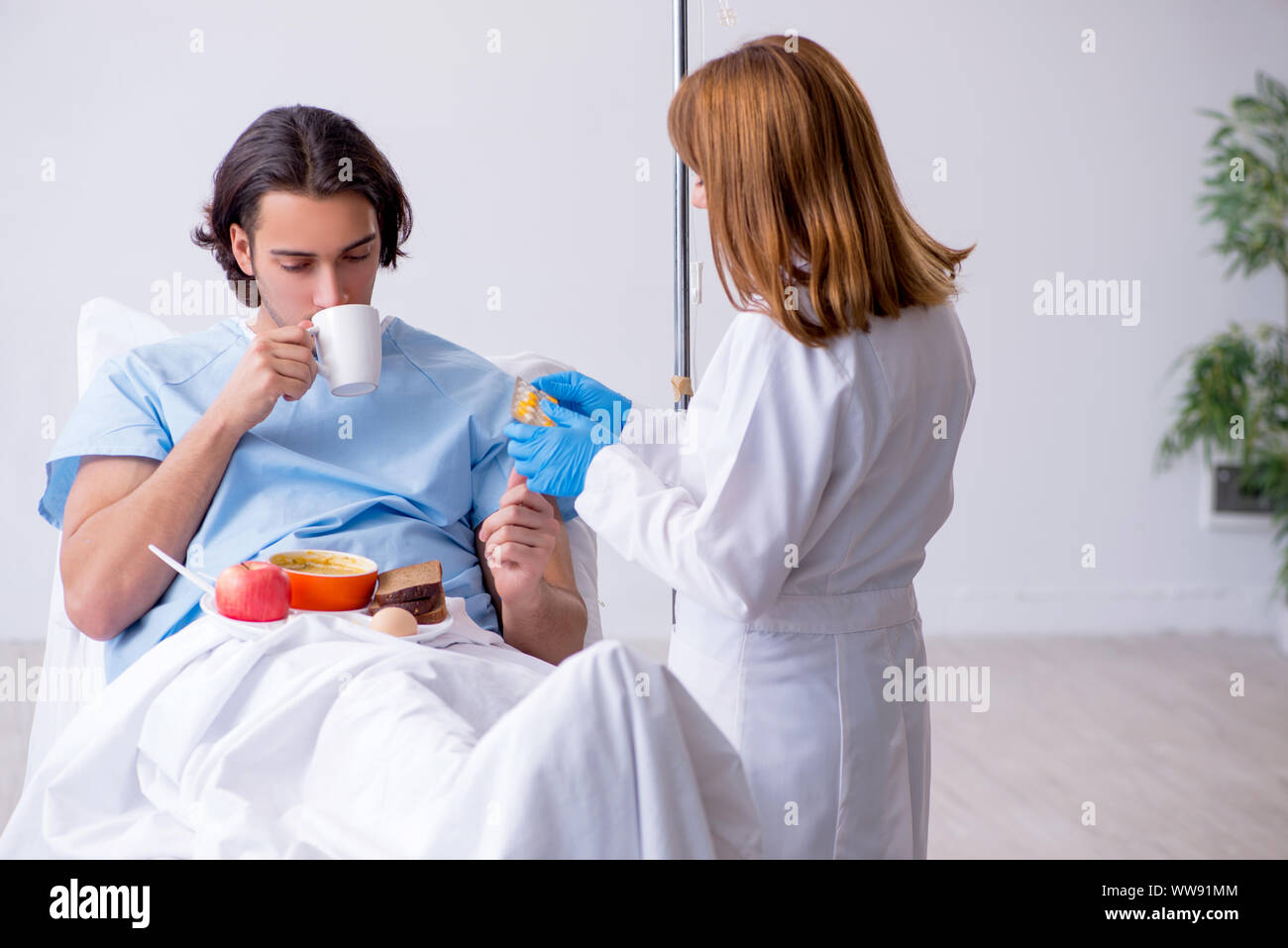 Woman sick in bed having tablets hi-res stock photography and images ...