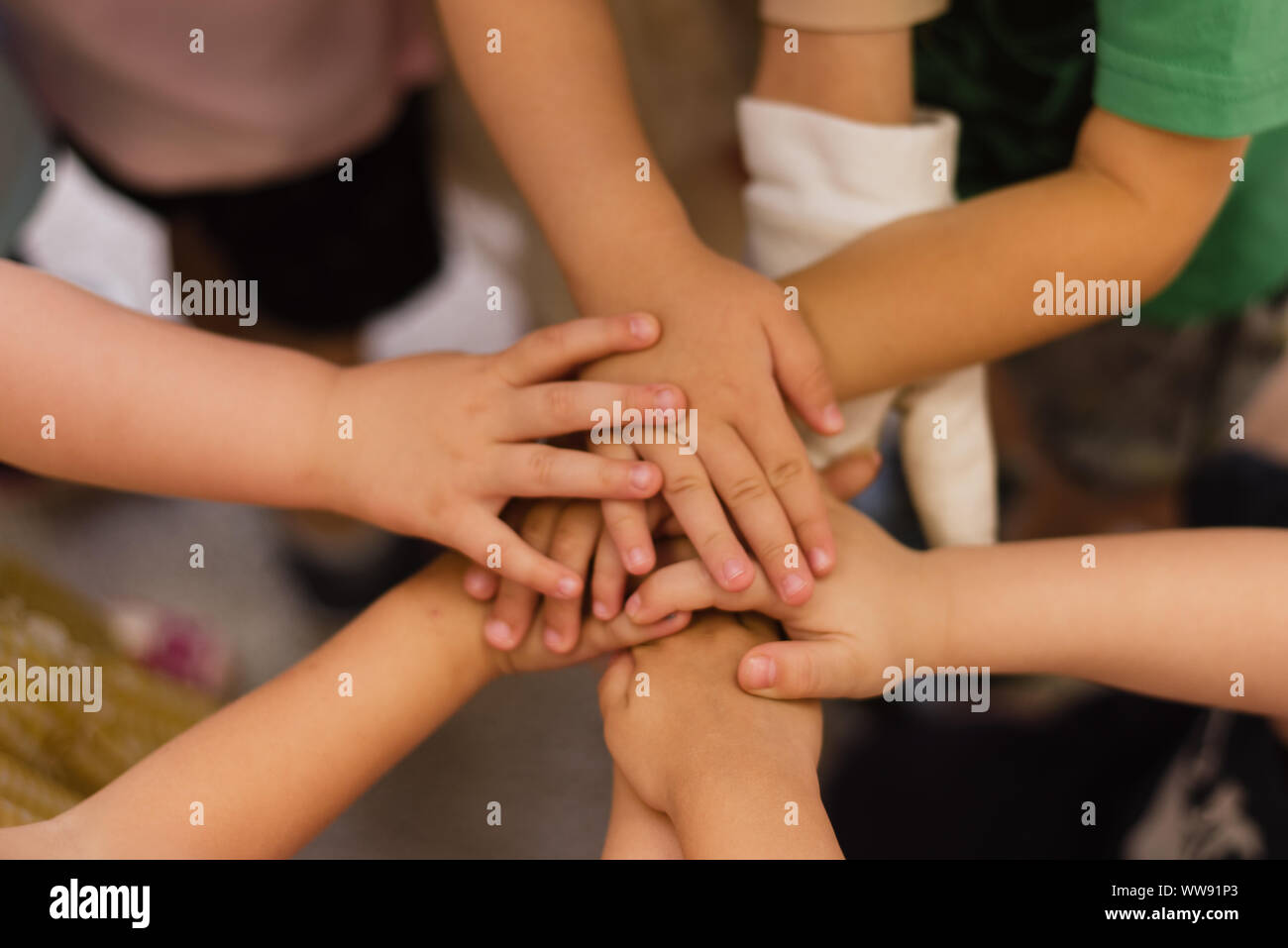 Children's hands piled on top of each other. Children's team and team ...