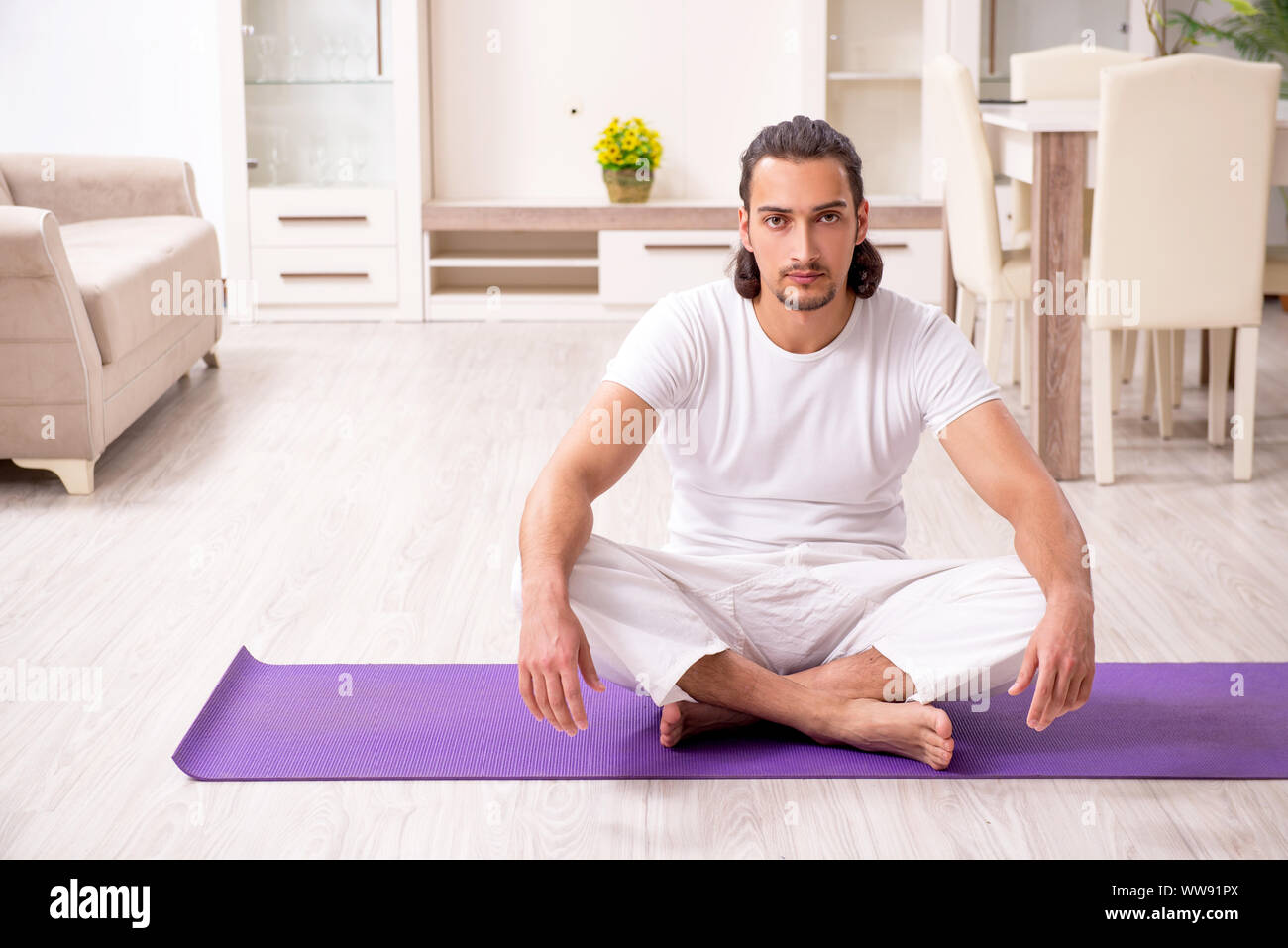 The young man doing physical exercises at home Stock Photo - Alamy