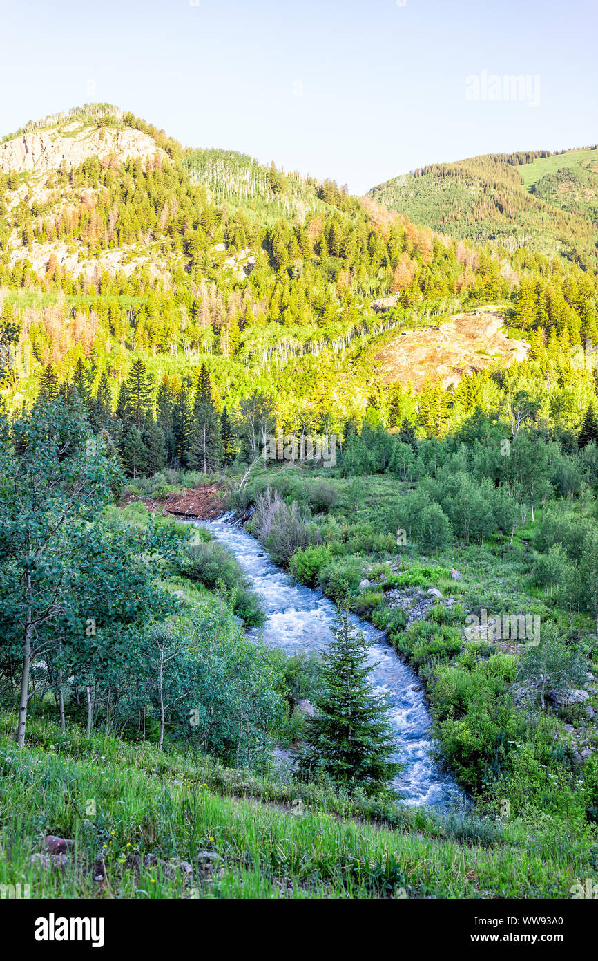 Vertical view of sunny river on Snowmass Lake hike trail in Colorado in ...