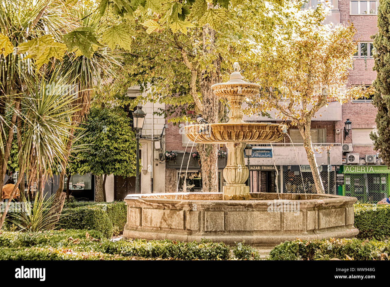 A round water fountain made of stone and cement; downtown Granada ...