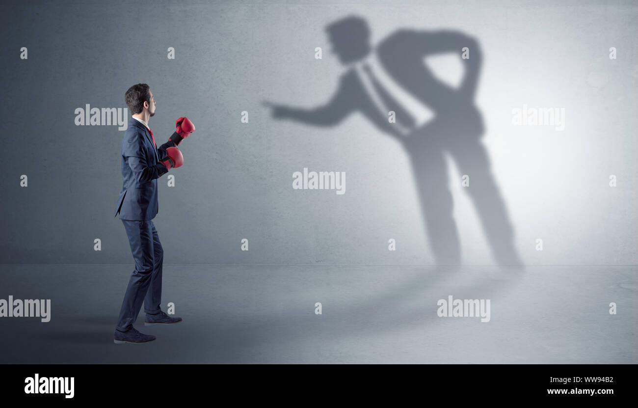 Businessman fighting with his bossy yelling shadow Stock Photo - Alamy