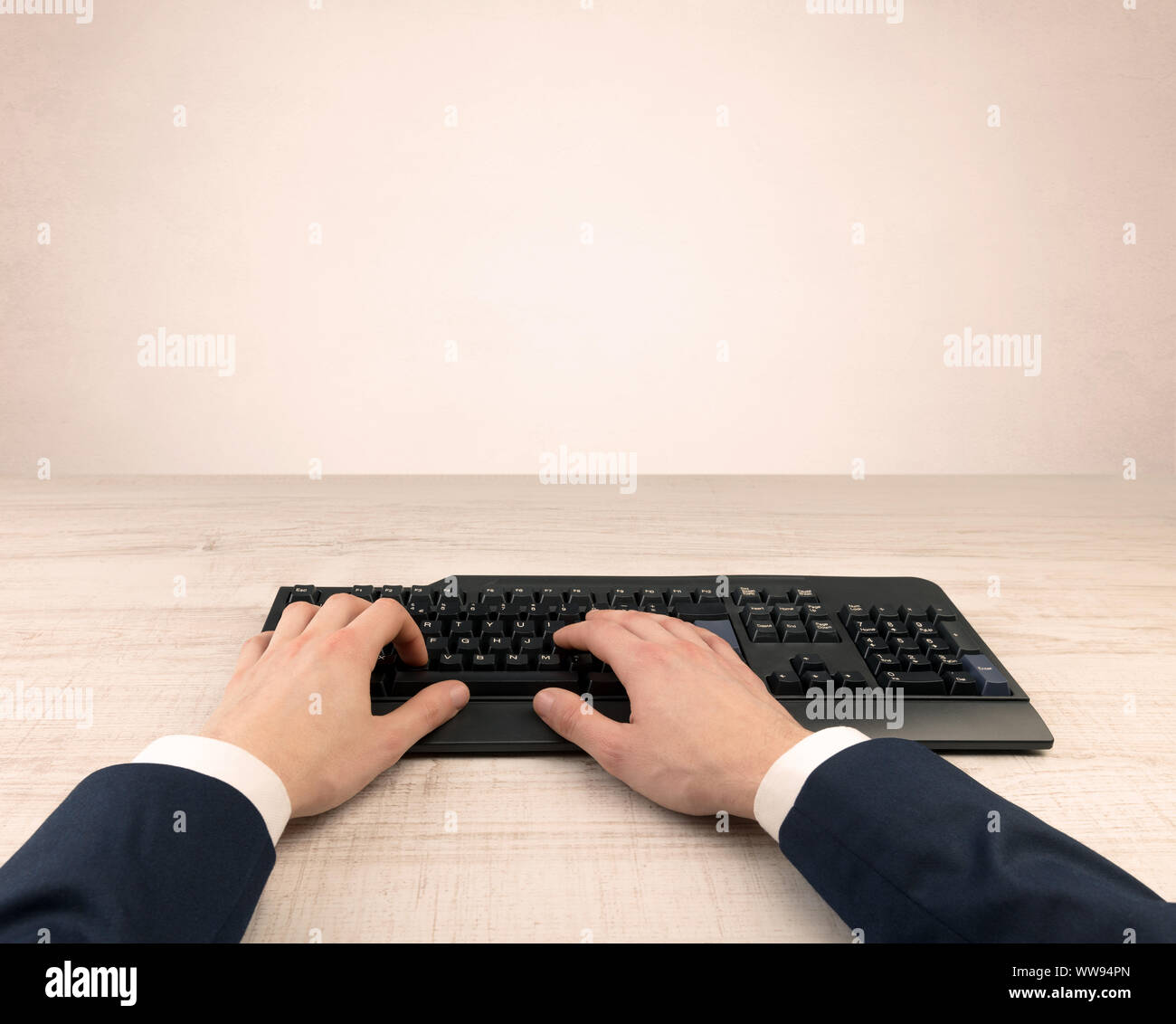 First person view of an elegant businessman hand typing on light ...