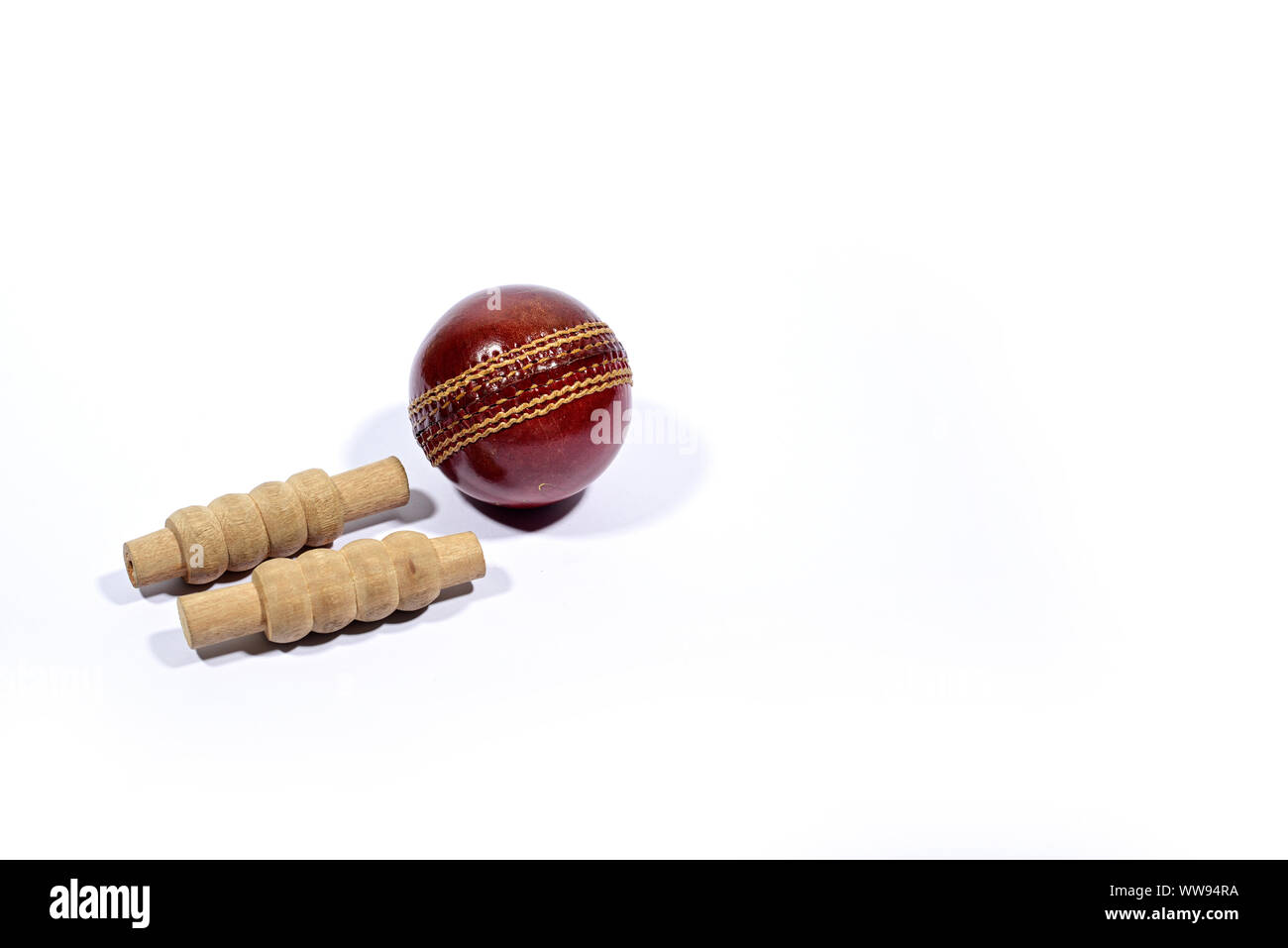 Cricket ball and bails are isolated on white background Stock Photo - Alamy