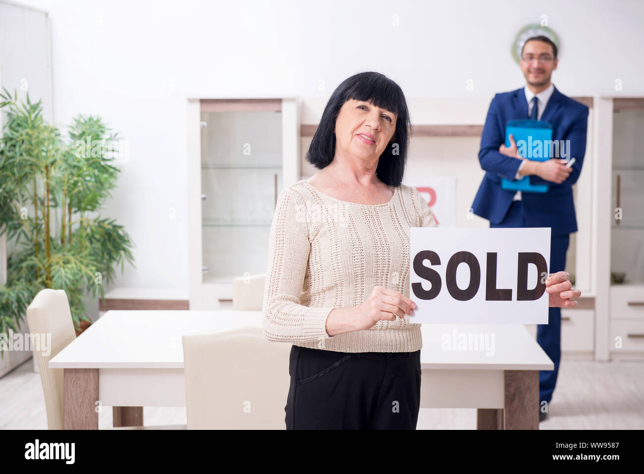 The male real estate agent and female client in the apartment Stock ...