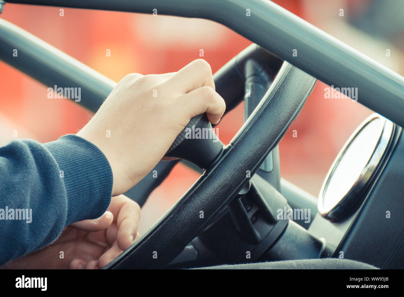 Man operating steering wheel in agricultural or industrial machine ...