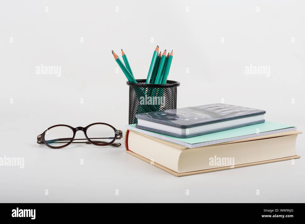 pen, reading glasses, book and notebook on white background Stock Photo ...