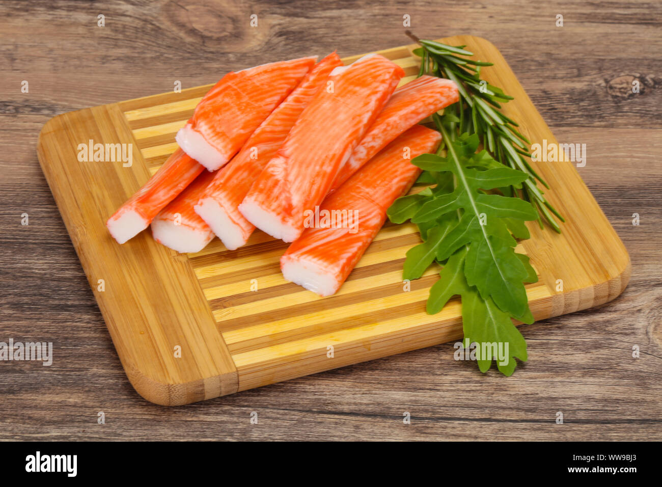 Crab stick surimi over wooden board Stock Photo - Alamy