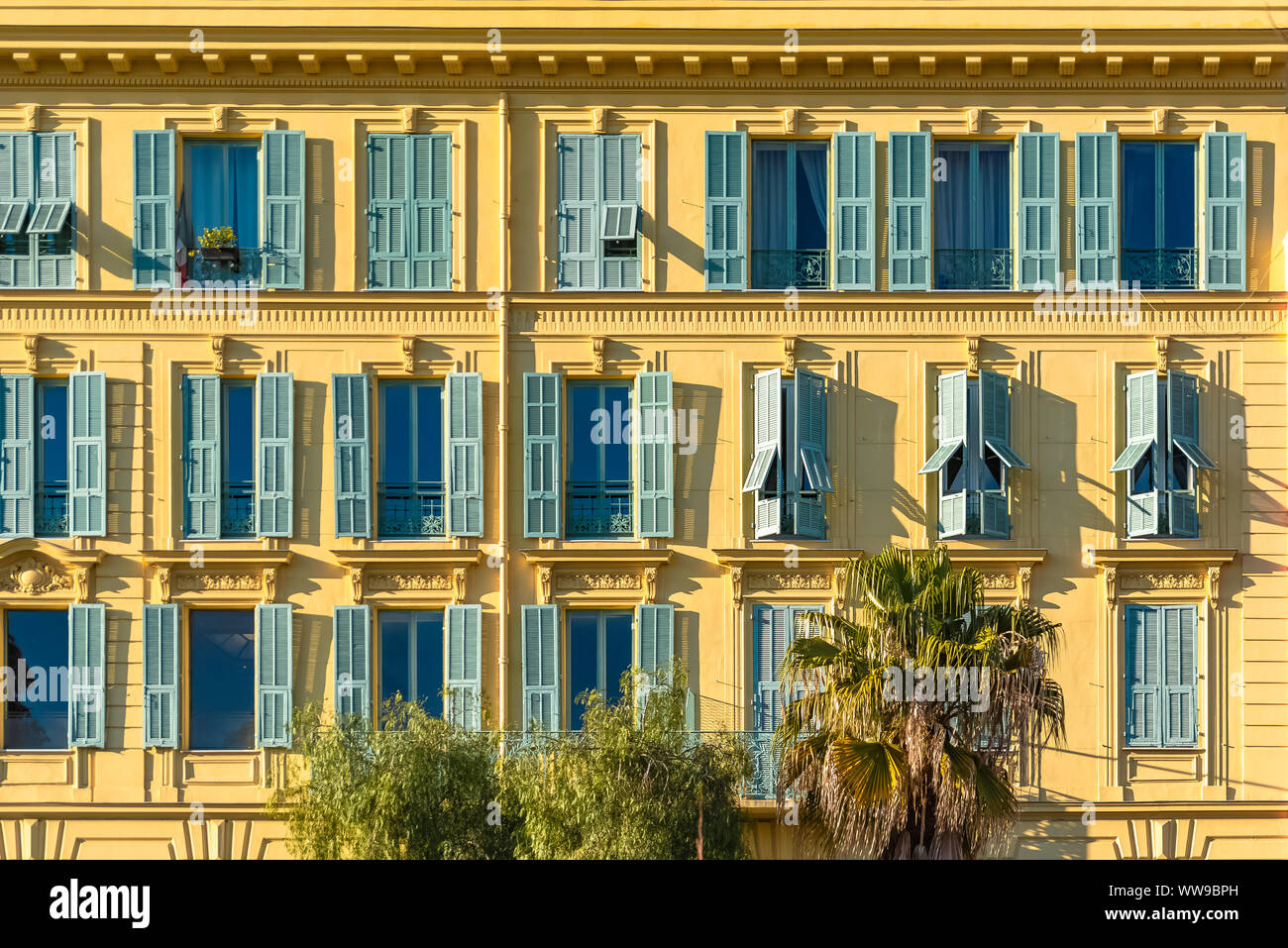 Nice, France, colorful facade, with typical windows and shutters, in a ...