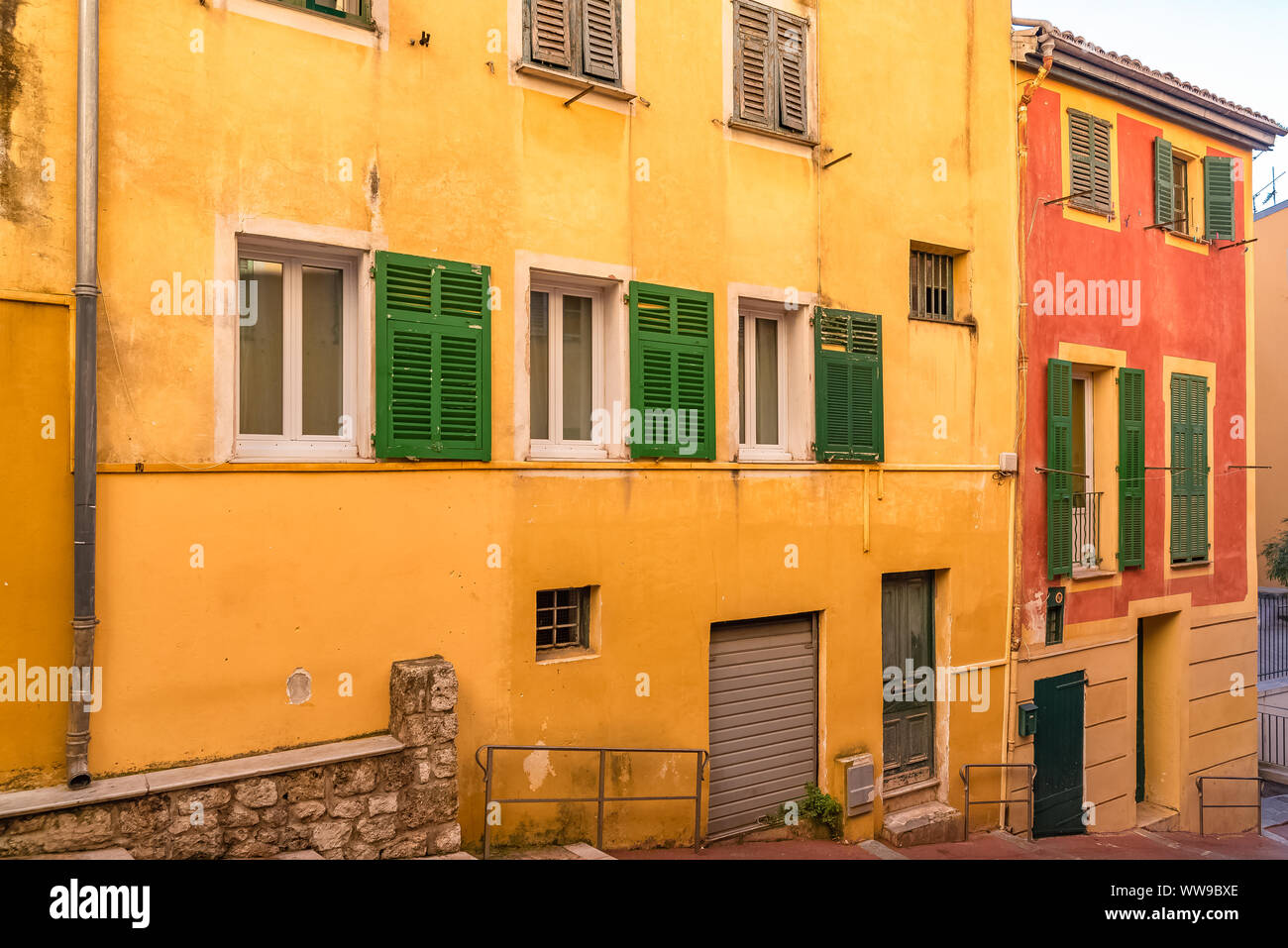 Nice, France, colorful facade, with typical windows and shutters, in a ...