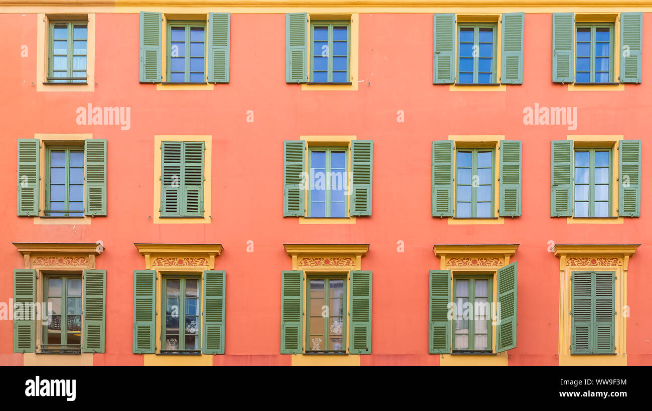 Nice, France, colorful facade, with typical windows and shutters, in a ...