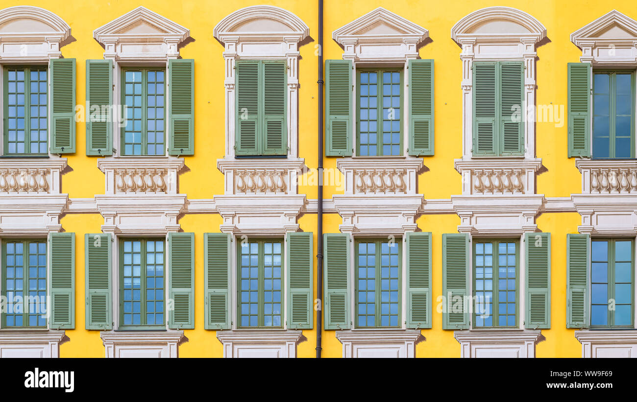 Nice, France, colorful facade, with typical windows and shutters, in a ...