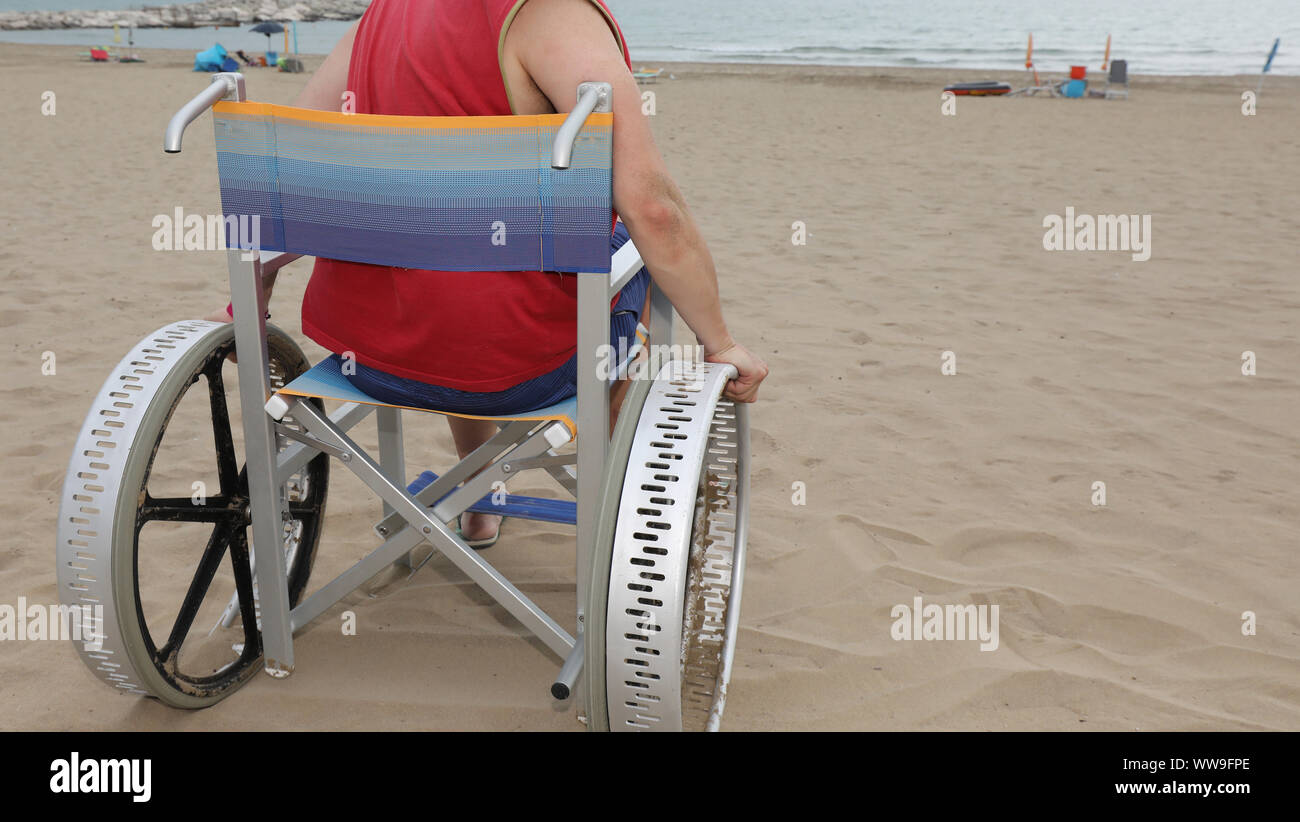 detail of a special wheelchair with big wheels to move on the sandy ...