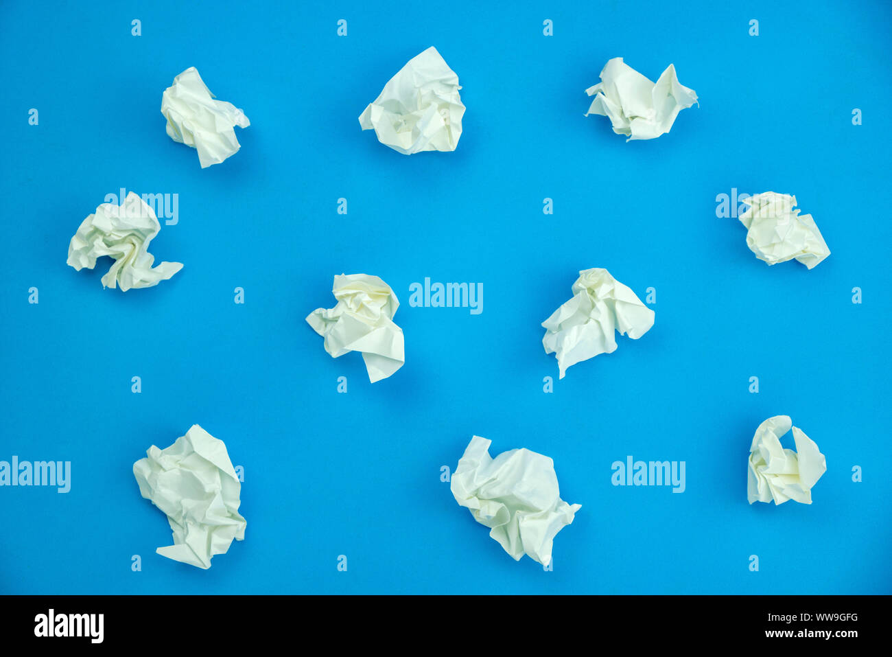 Various white paper ball isolated on blue background Stock Photo - Alamy