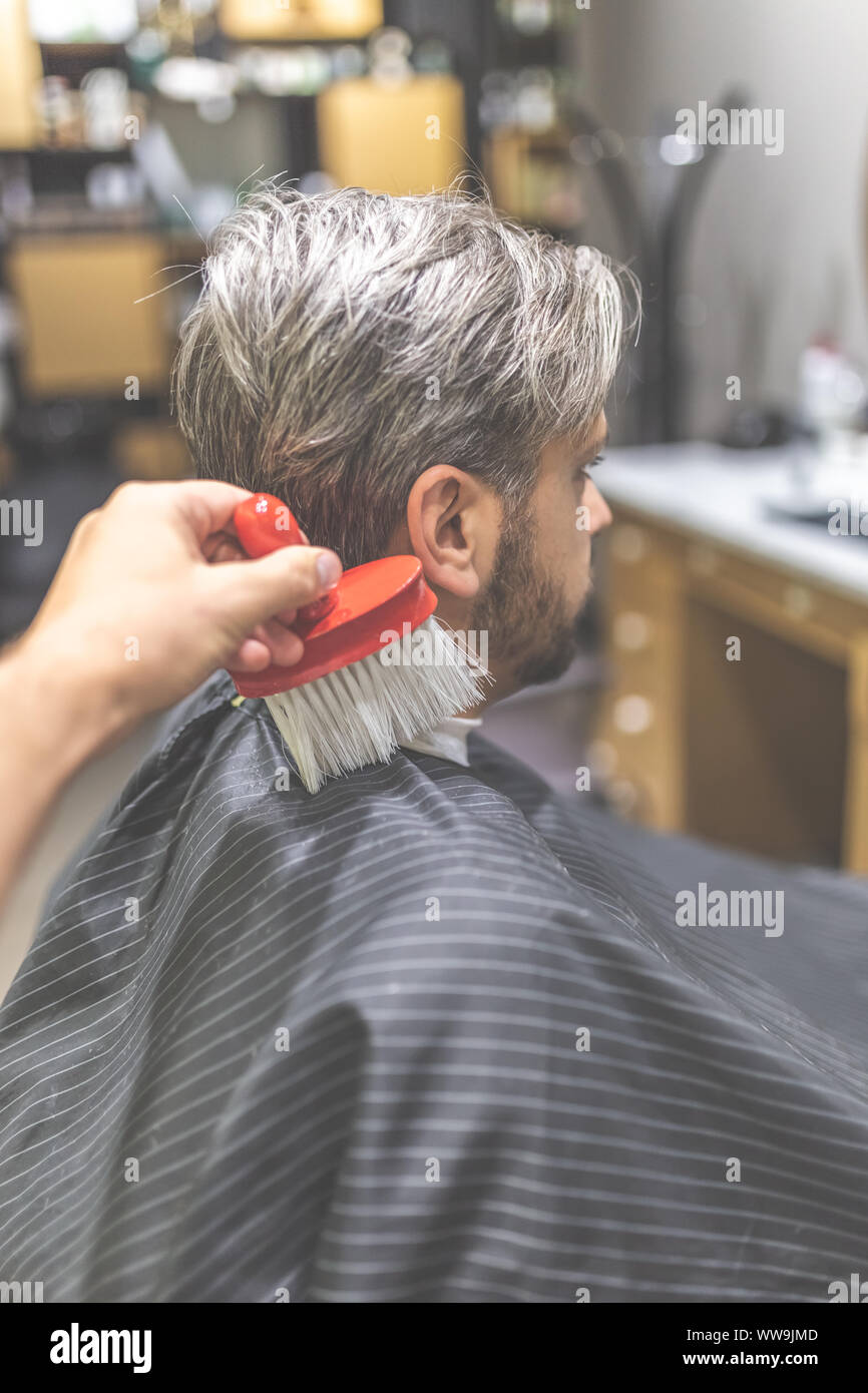 Male client and hairdresser cleaning neck with brush Stock Photo - Alamy