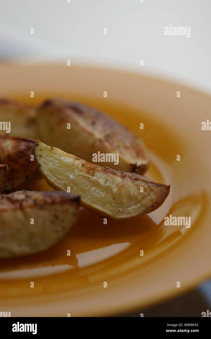 ready baked potatoes in a plate closeup Stock Photo - Alamy