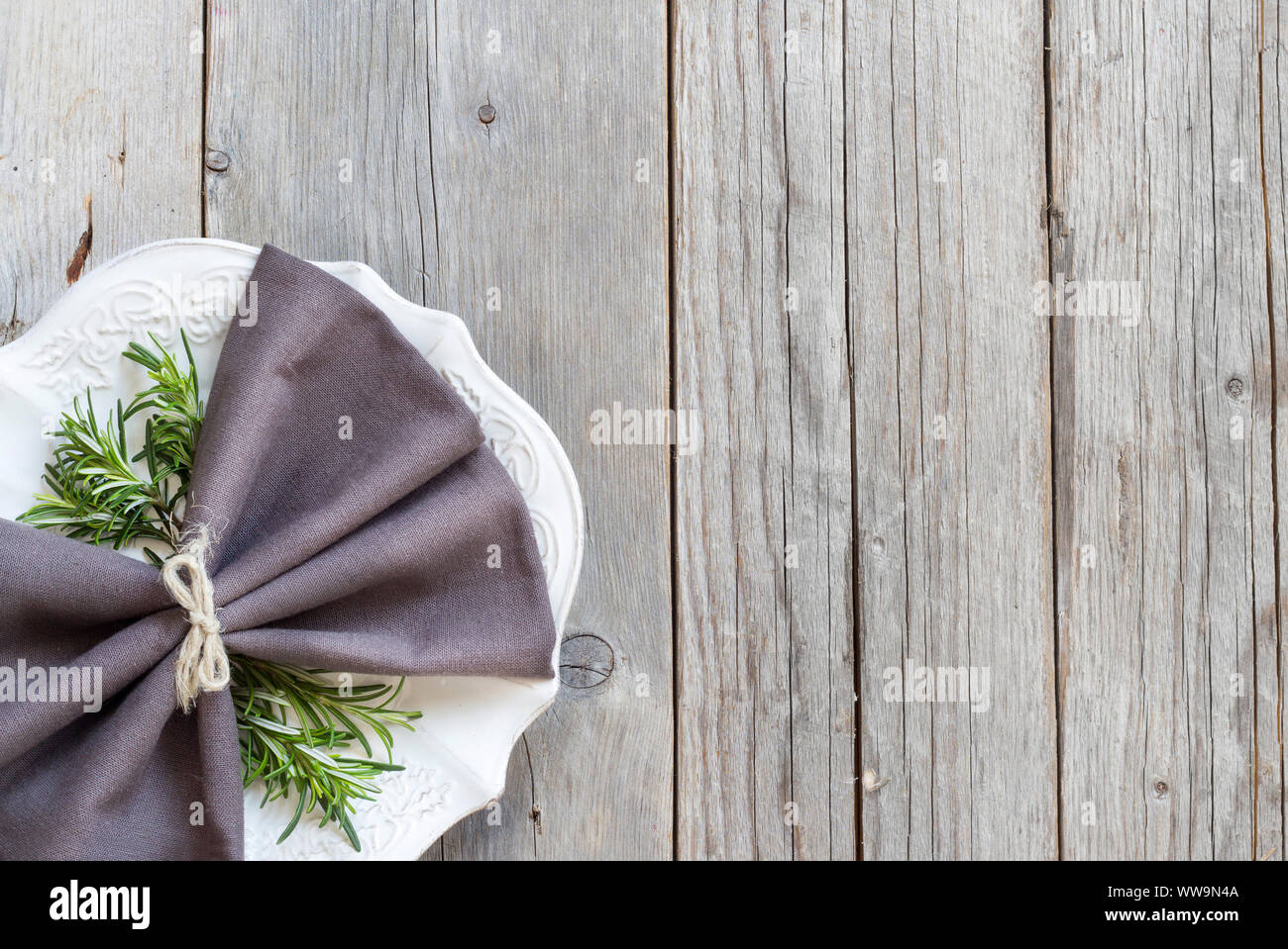 Vintage Table setting with rosemary decor on wood Stock Photo - Alamy