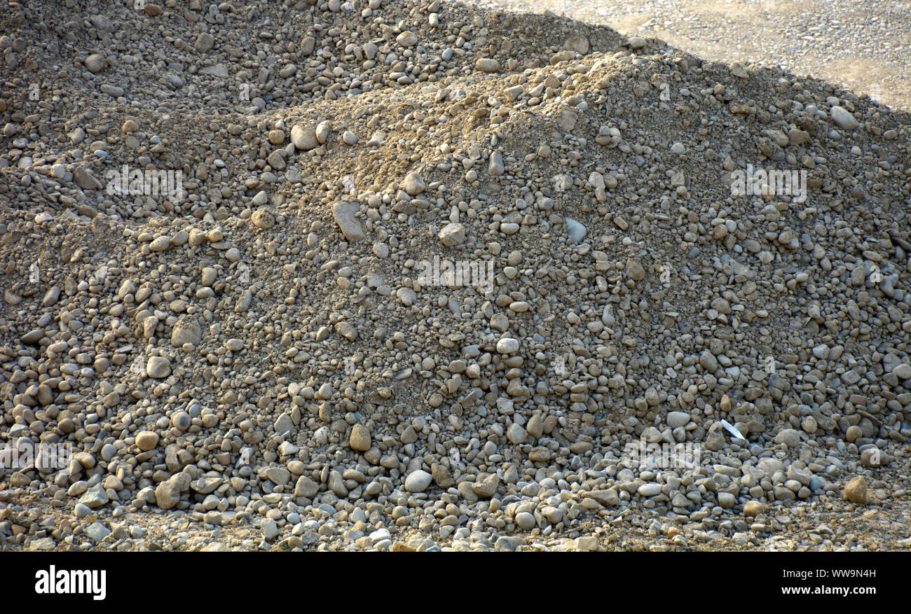 pile of gravel and stones at a construction site in an excavation pit ...