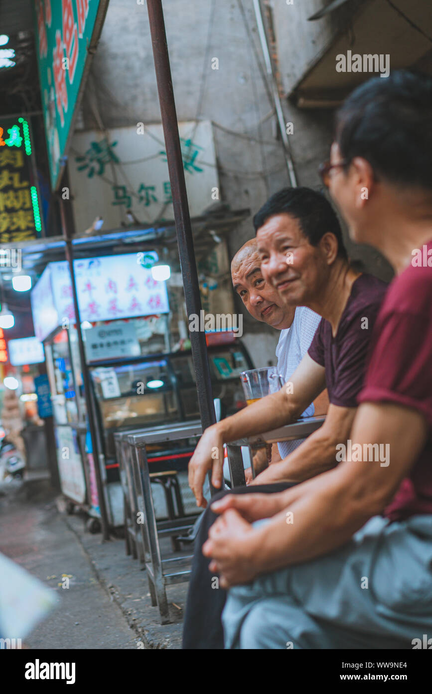 Xian, China - July 2019 : Group of male friends talking and chatting ...