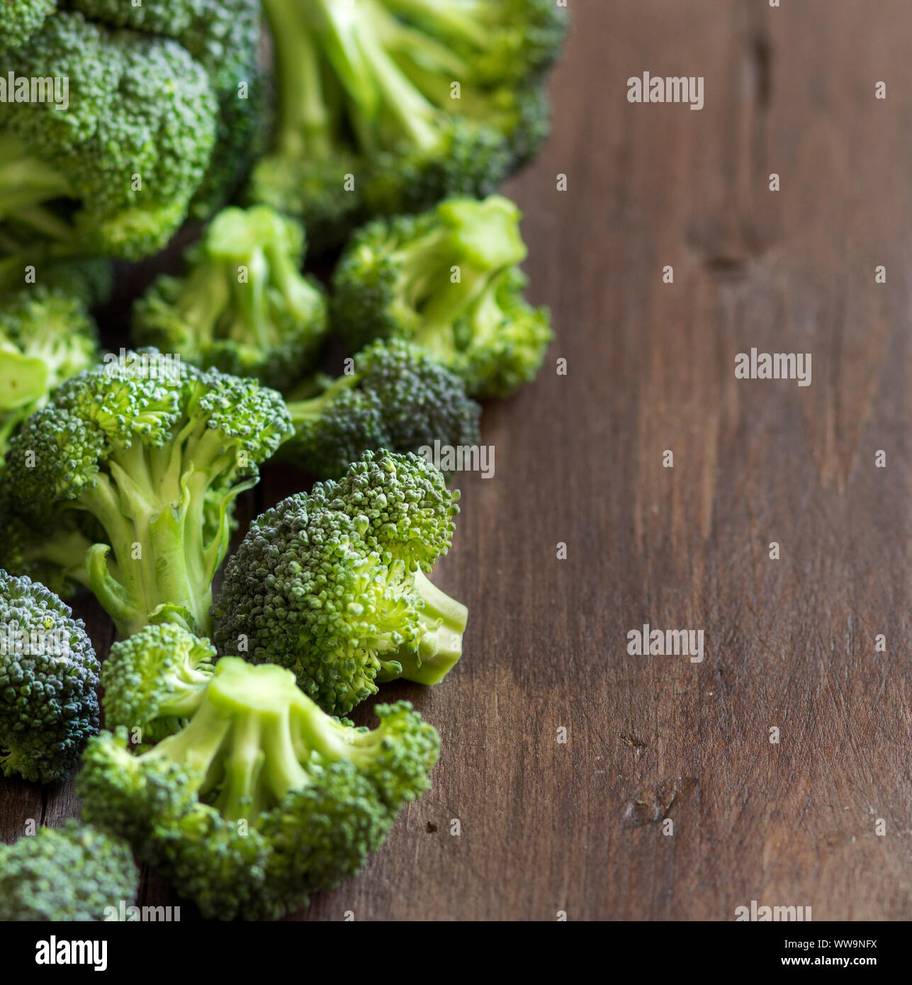 Fresh broccoli on old wooden table close up Stock Photo - Alamy
