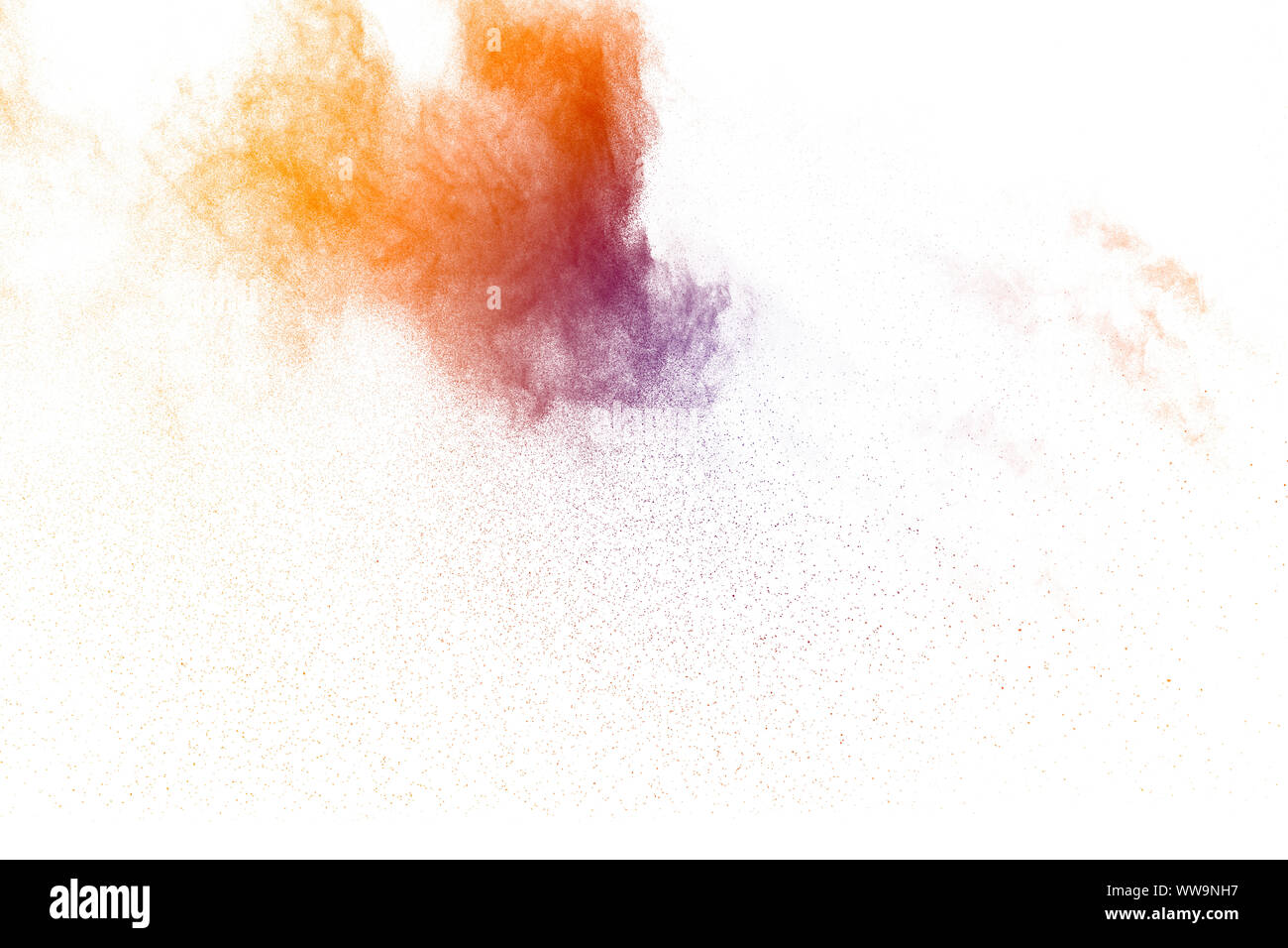 Abstract light orange powder explosion on white background. Freeze ...