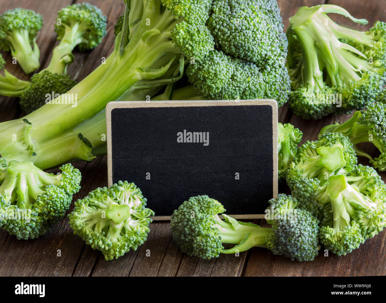 Fresh broccoli small chalkboard on old wooden table Stock Photo - Alamy