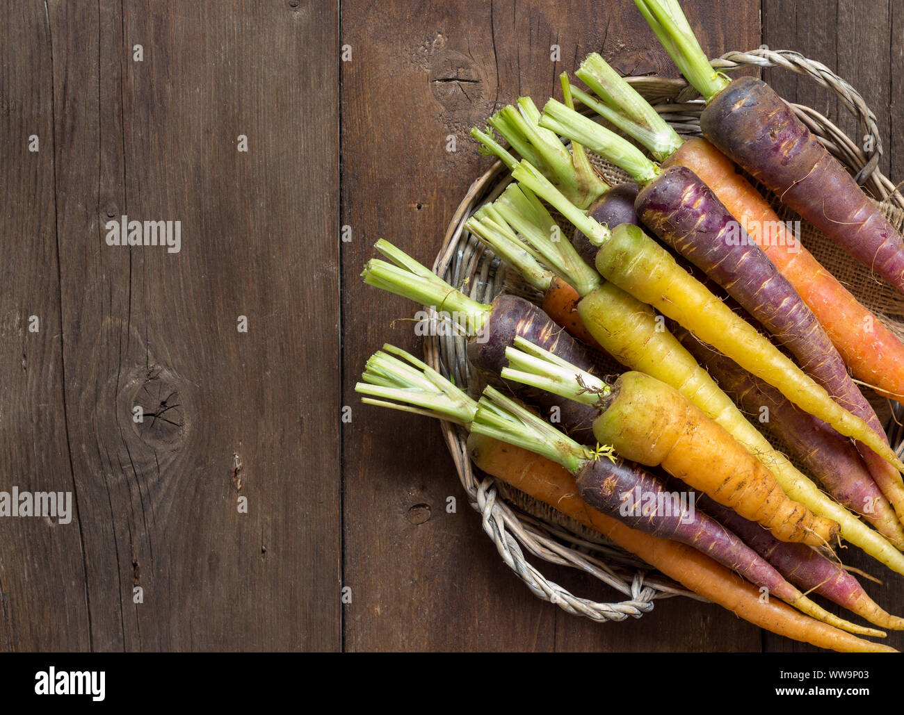 Fresh organic rainbow carrots on a wooden table Stock Photo - Alamy