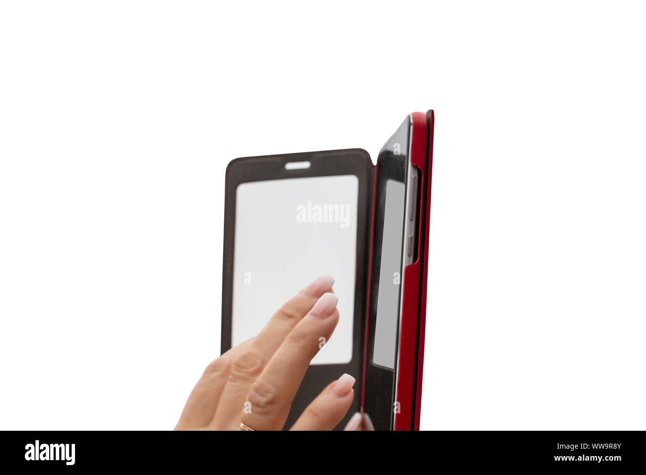 The fingers of a female hand operate the touchscreen of a mobile phone ...