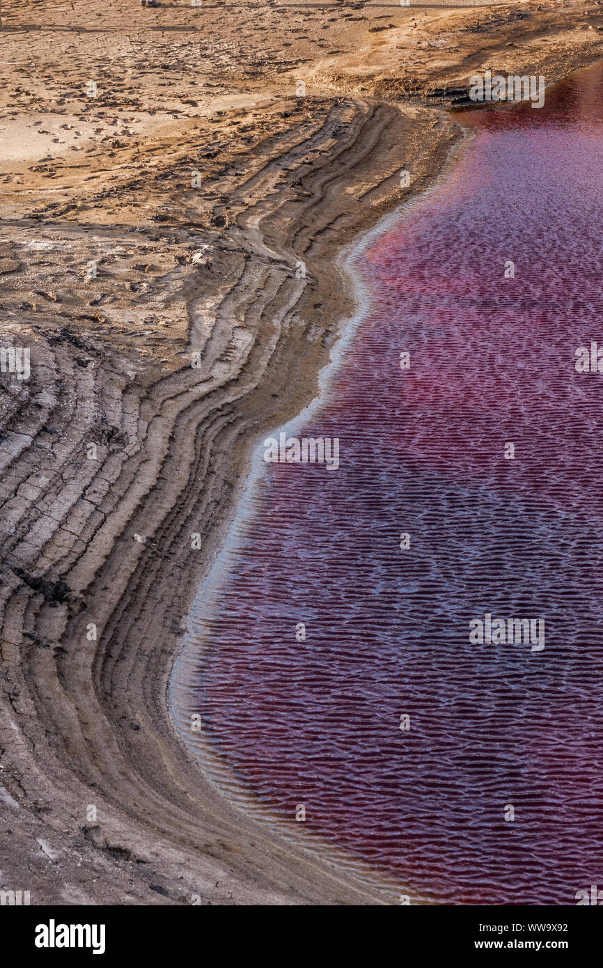 Lake with red bloody water at the bottom of quarry Stock Photo - Alamy