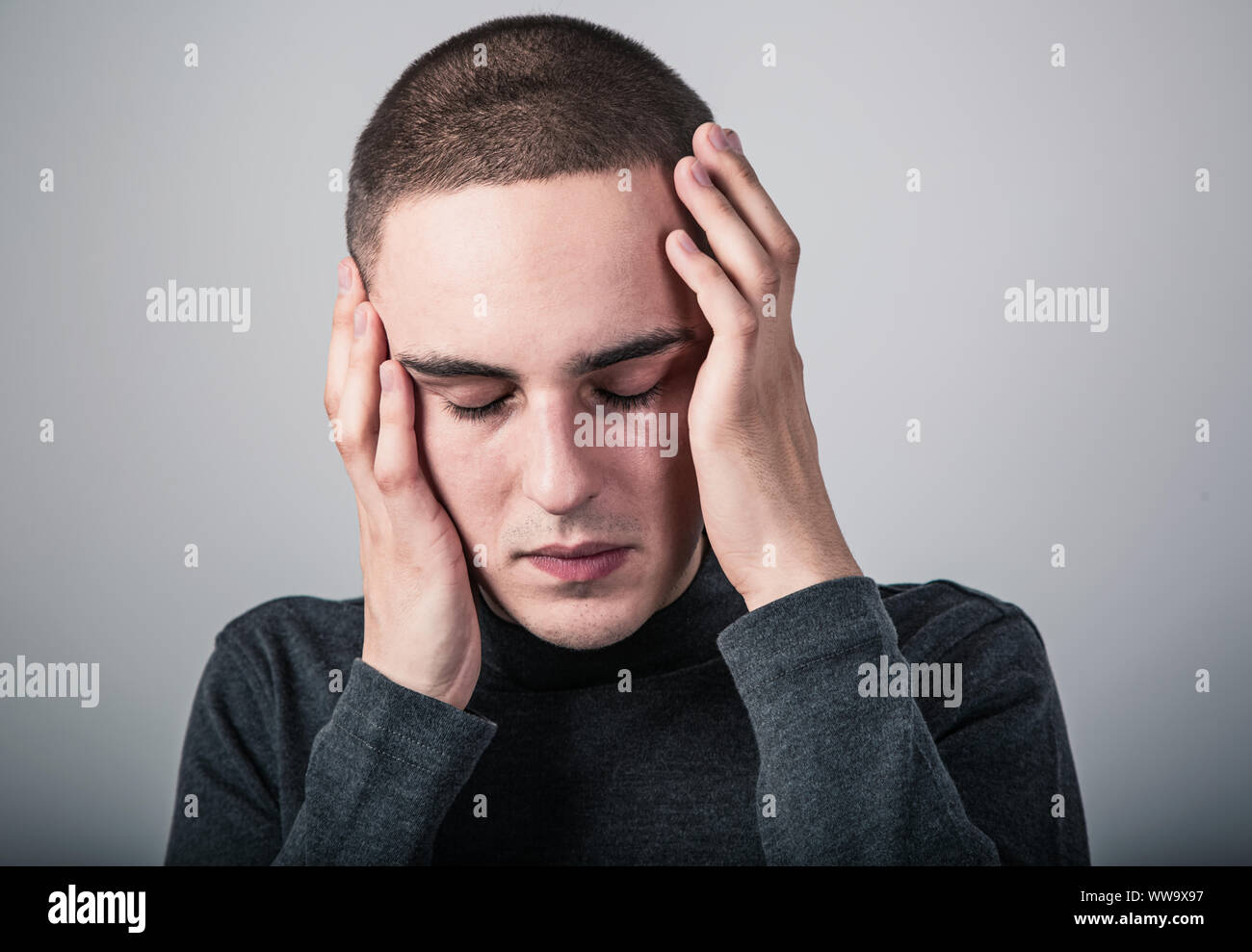 Unhappy crying man with dropping tears on the face with headache ...