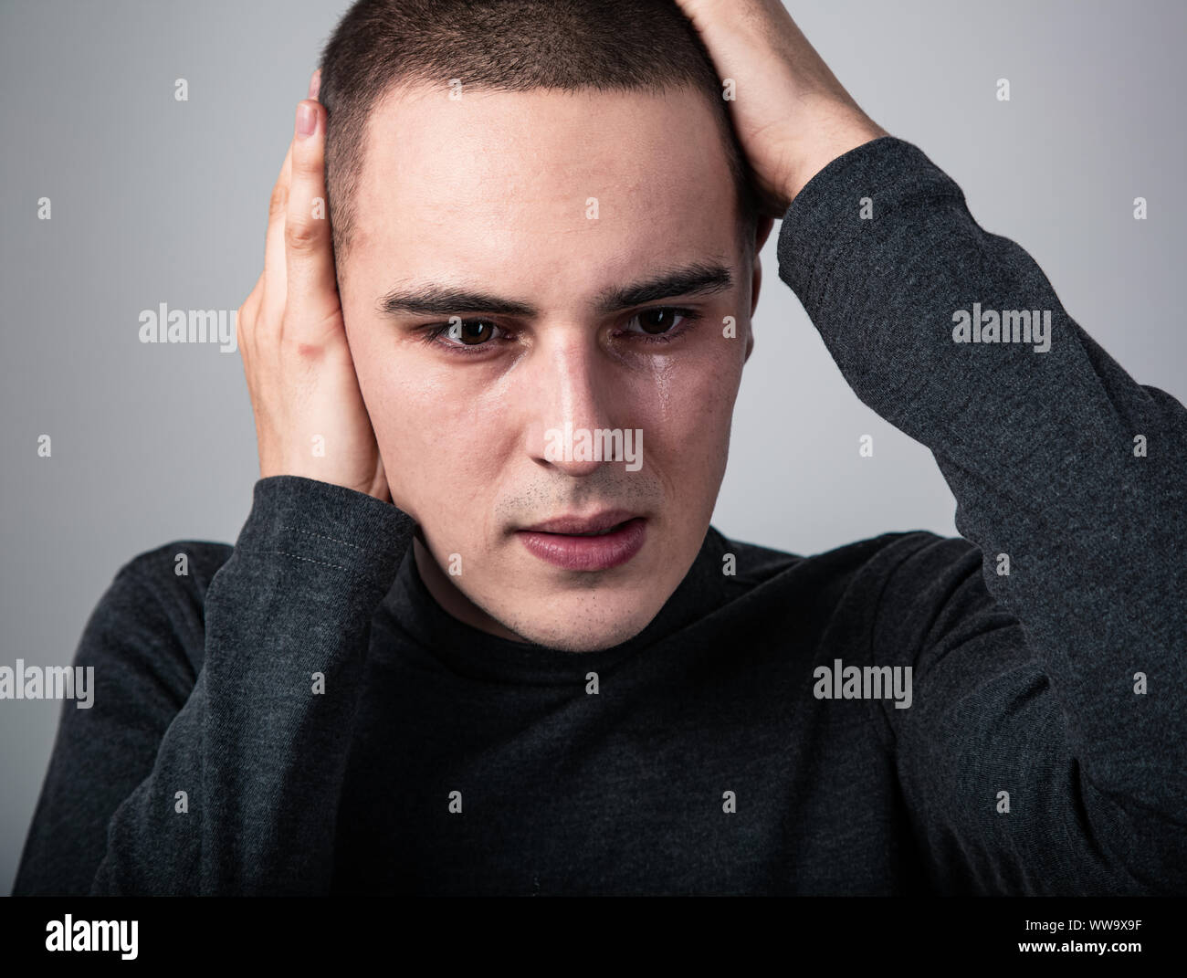 Unhappy crying man with dropping tears on the face with headache ...