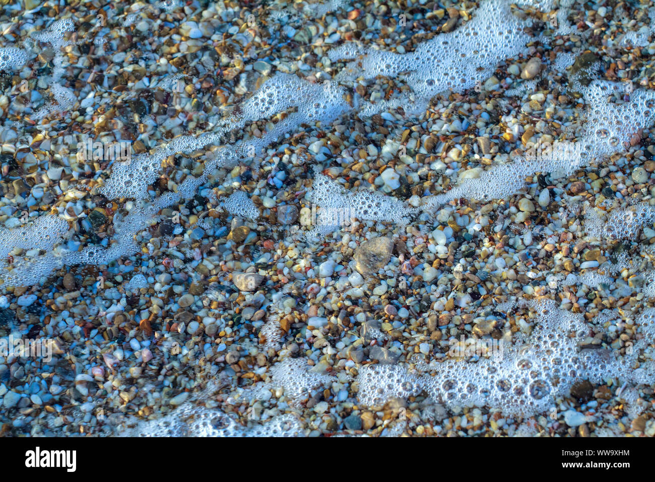 sea pebbles colored granite on the beach background stones. The shore ...
