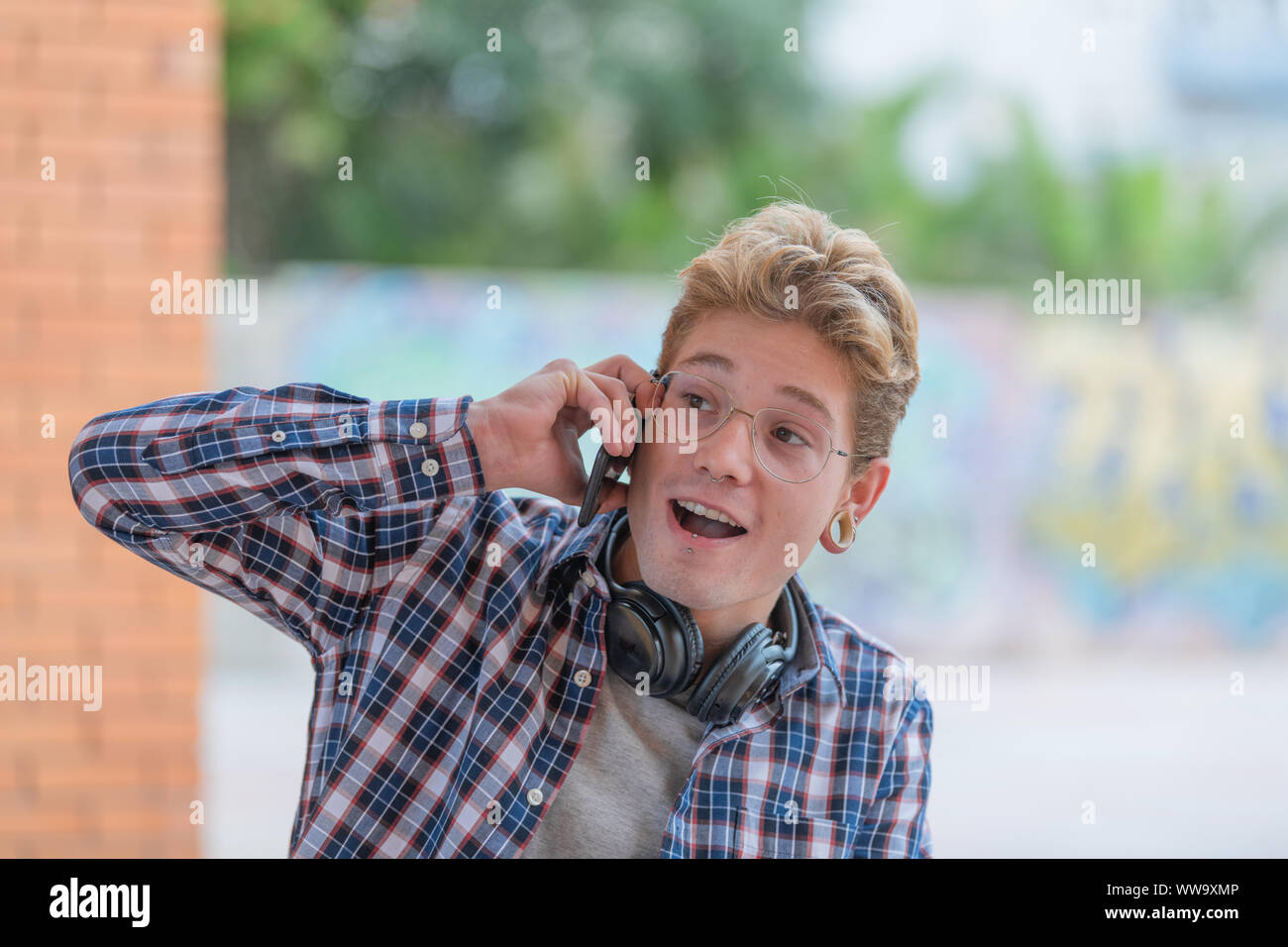 Young man talking on the phone with a rare expression on his face Stock ...
